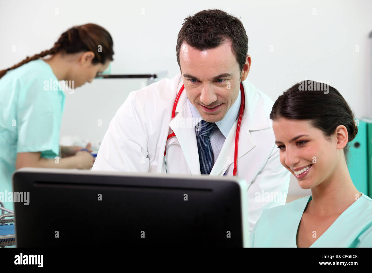 Doctor and nurse at a computer Stock Photo - Alamy