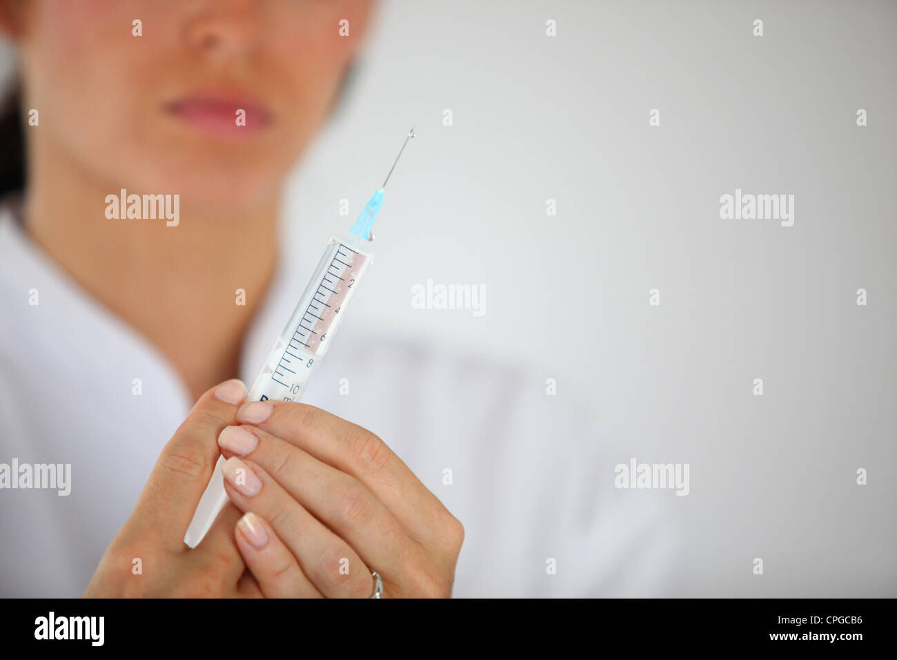 Nurse holding syringe Stock Photo - Alamy