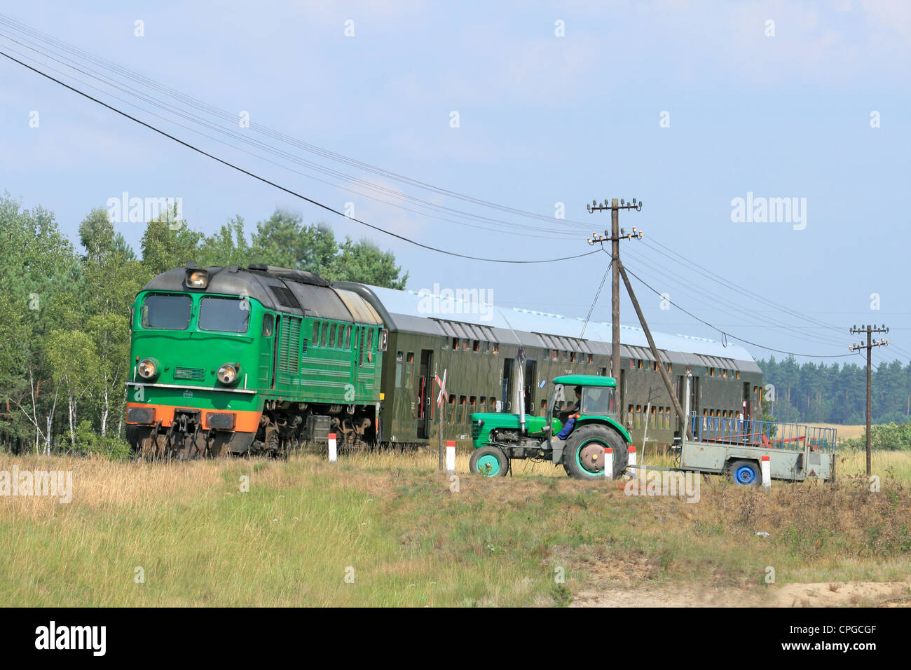 Passenger train passing the railroad crossing Stock Photo - Alamy