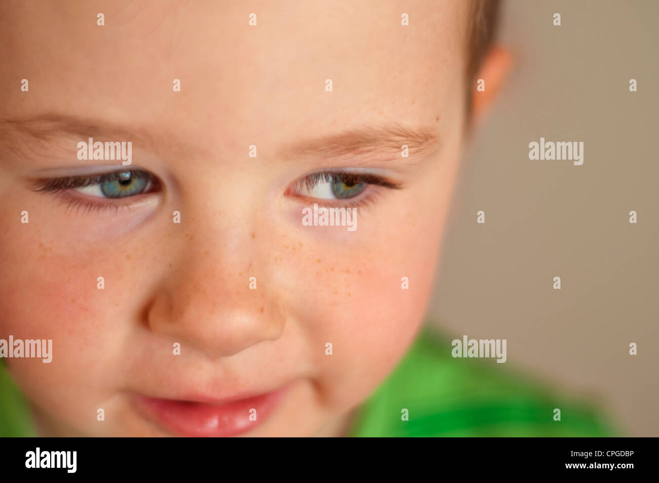 Cute little boy with camera focus on his beautiful clear blue eyes ...
