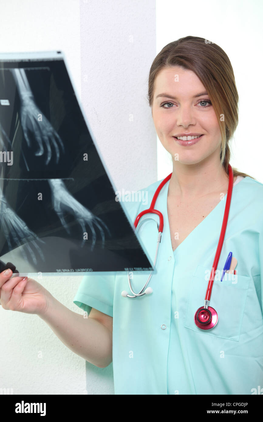 Nurse smiling with X-ray Stock Photo - Alamy