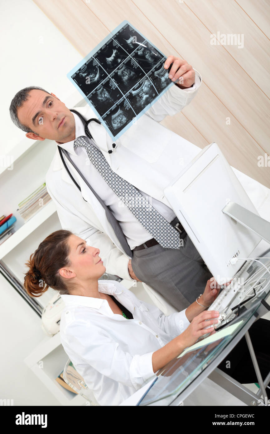 Doctors looking at x-rays Stock Photo - Alamy