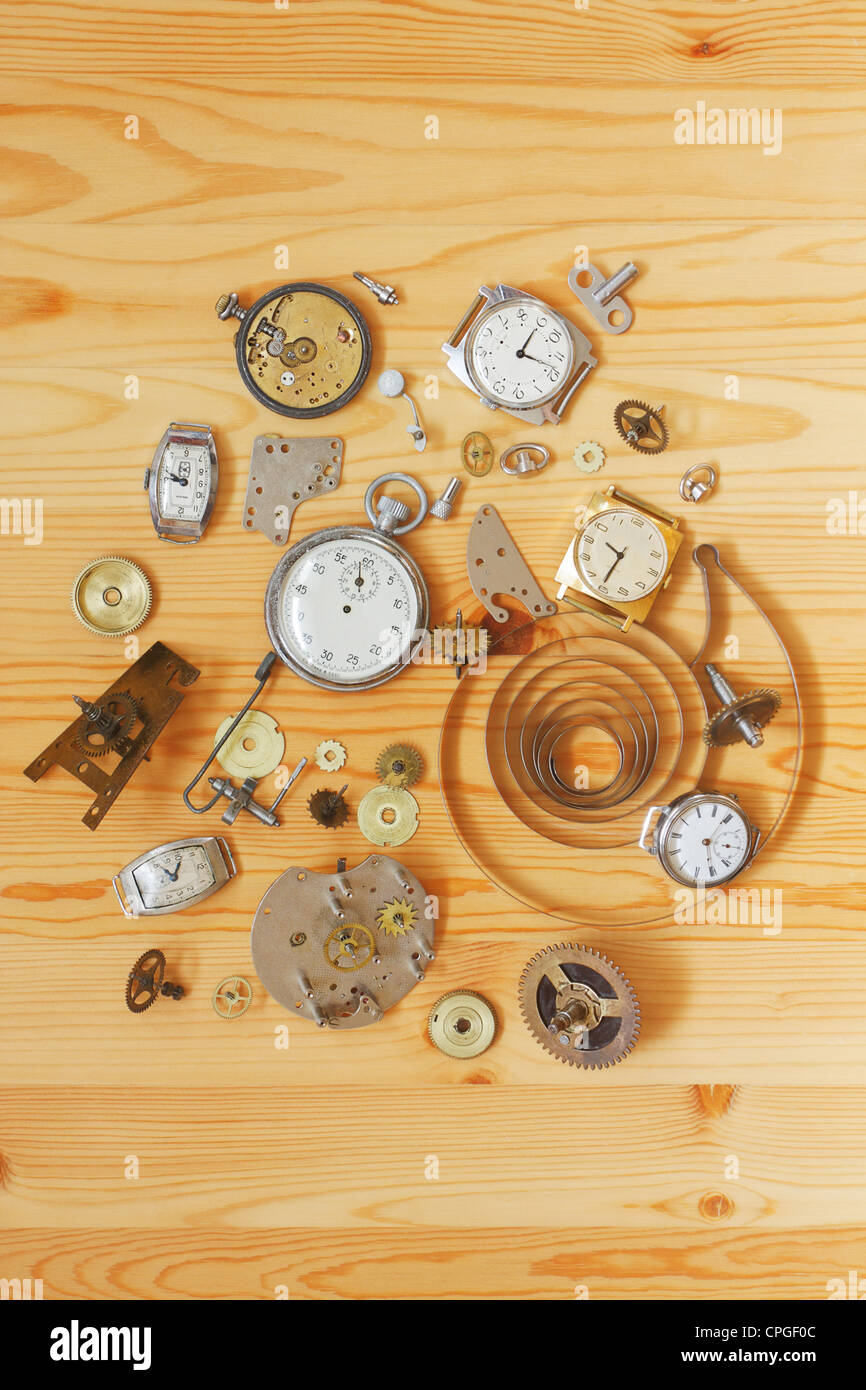 The old mechanical clocks and the details of their mechanisms lie on a ...