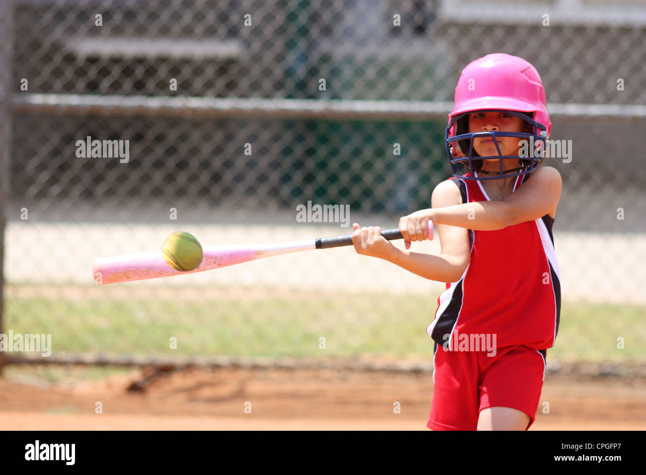Young girl playing in a softball game Stock Photo - Alamy