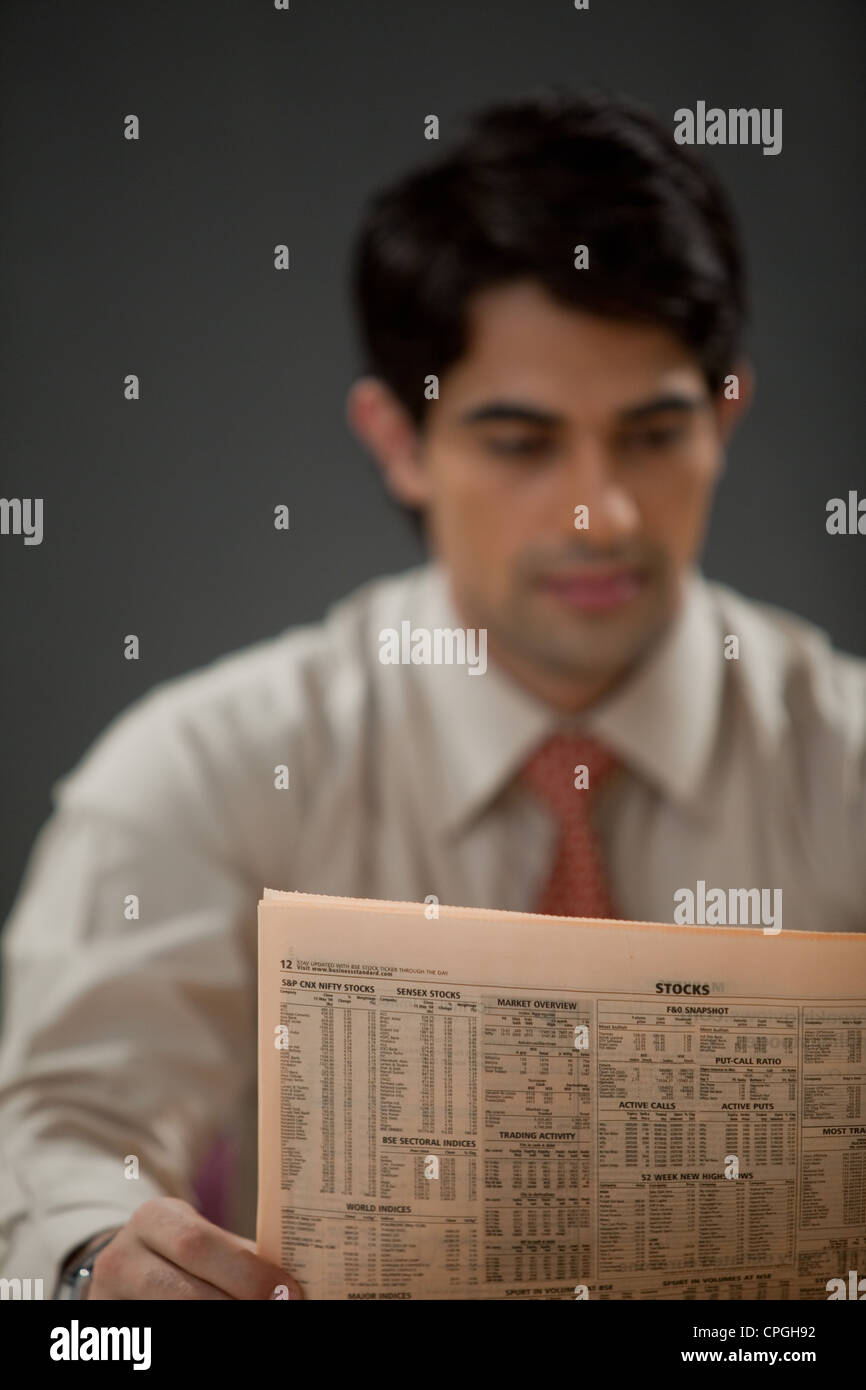 young-businessman-reading-newspaper-stock-photo-alamy