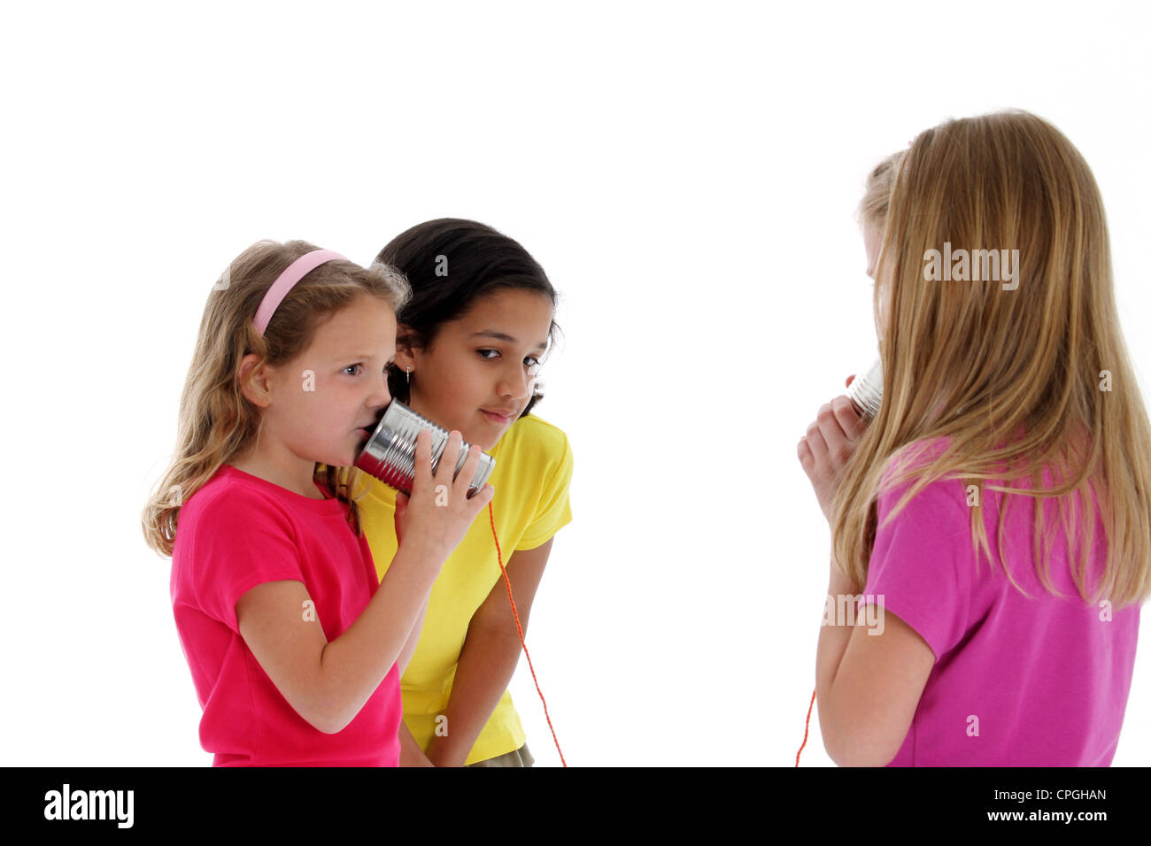 Kids playing with a toy telephone on white background Stock Photo - Alamy