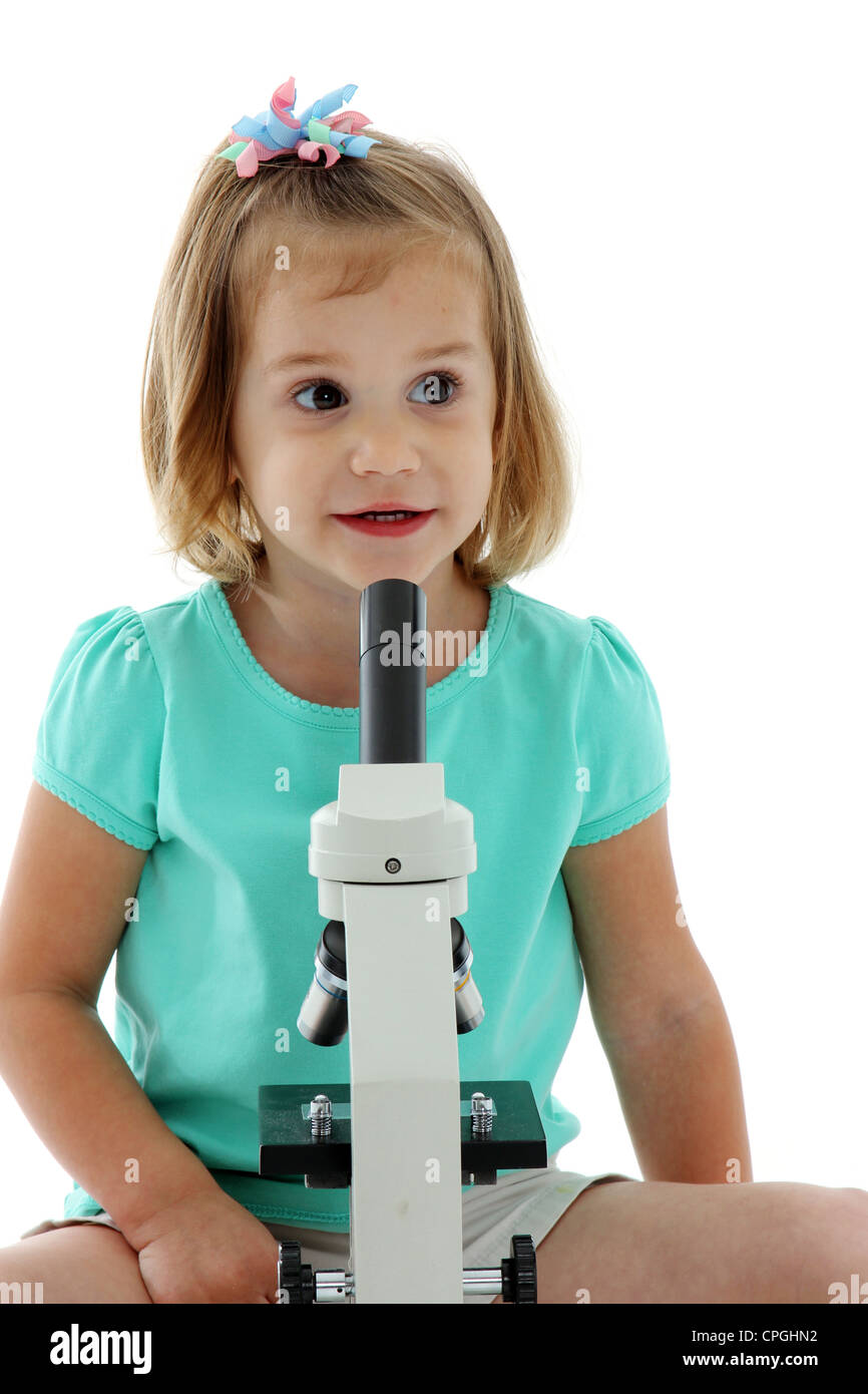 Toddler looking through a microscope on white background Stock Photo ...