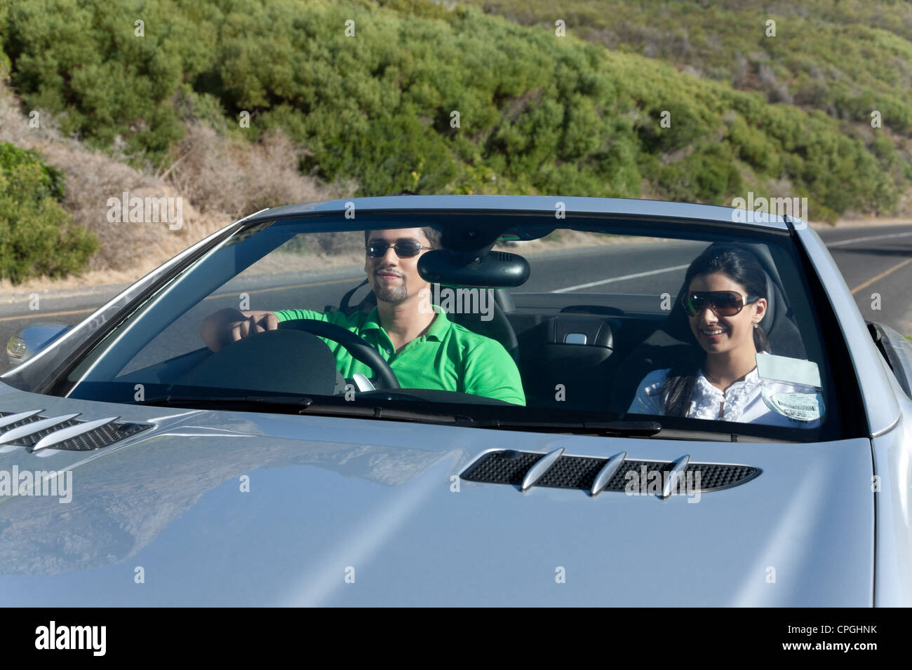 Couple riding in a convertible car, smiling Stock Photo - Alamy