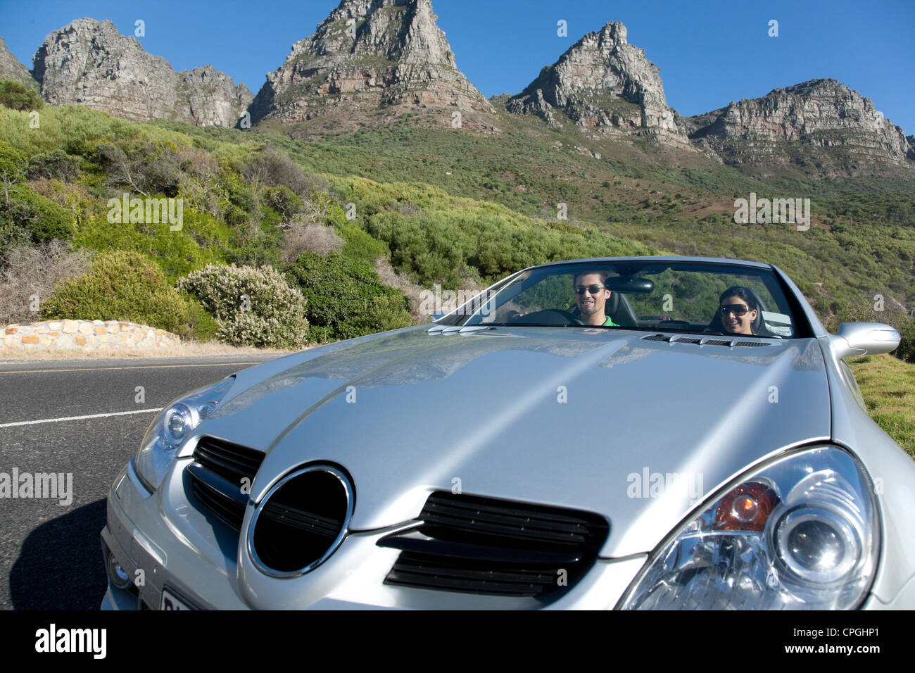 Couple riding in a convertible car, smiling Stock Photo - Alamy