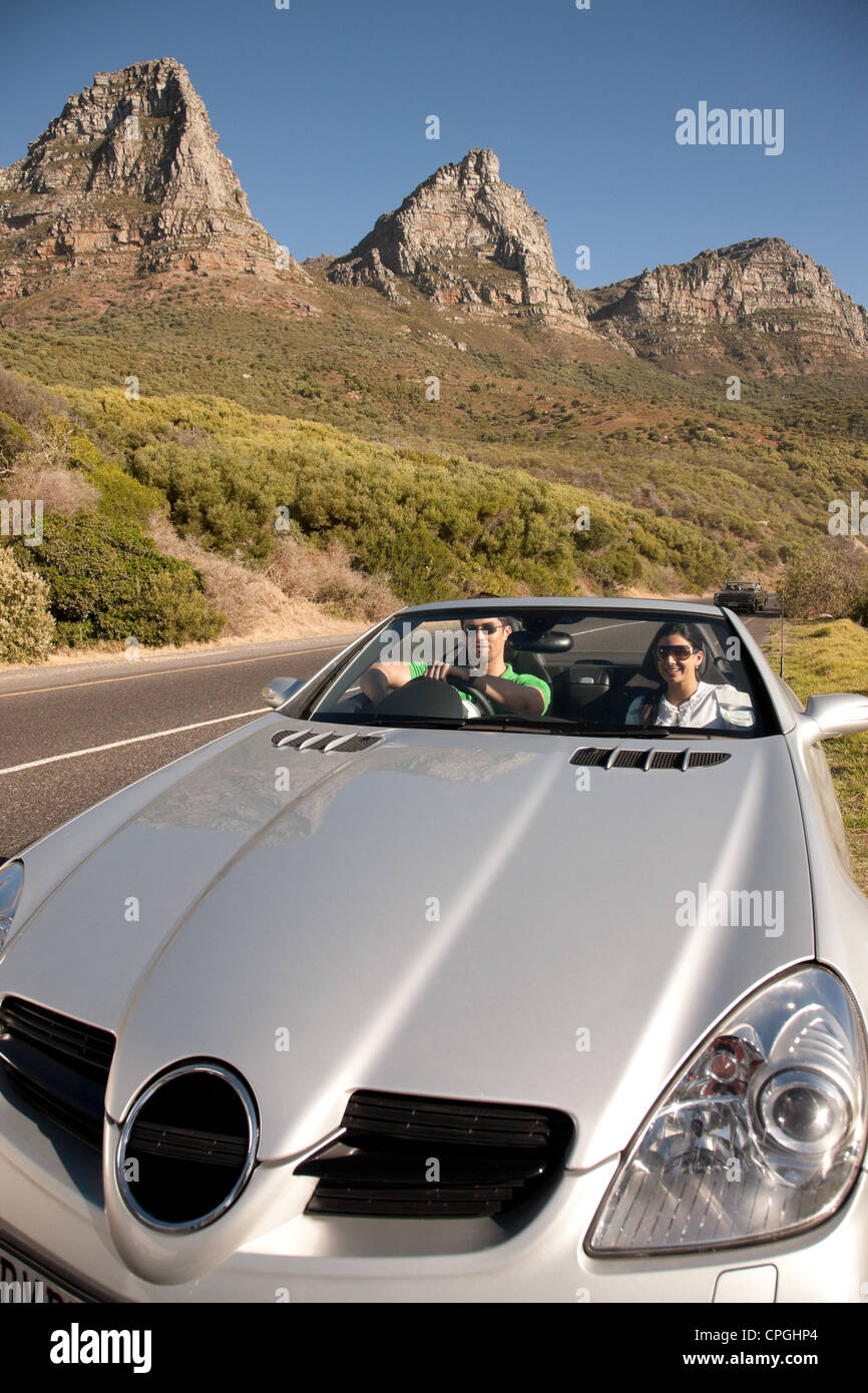 Couple riding in a convertible car, smiling Stock Photo - Alamy