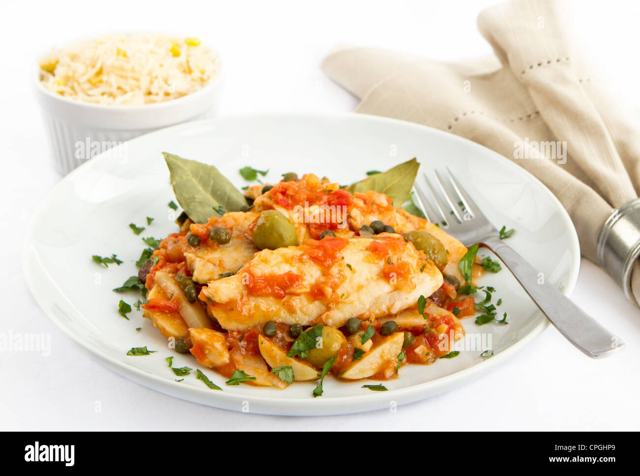 Tilapia fish prepared Veracruz style with tomatoes, potatoes, capers ...