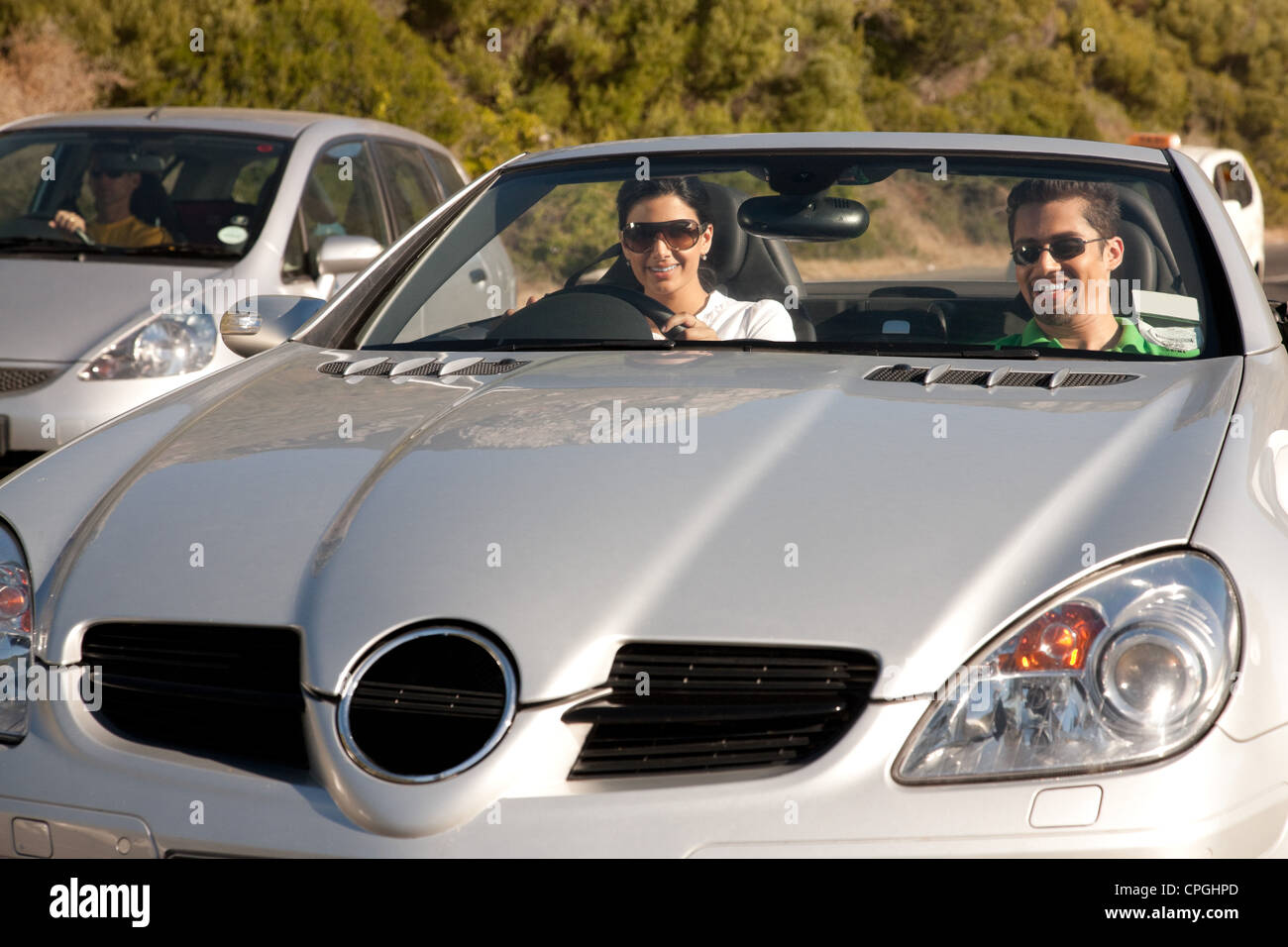 Couple riding in a convertible car, smiling Stock Photo - Alamy