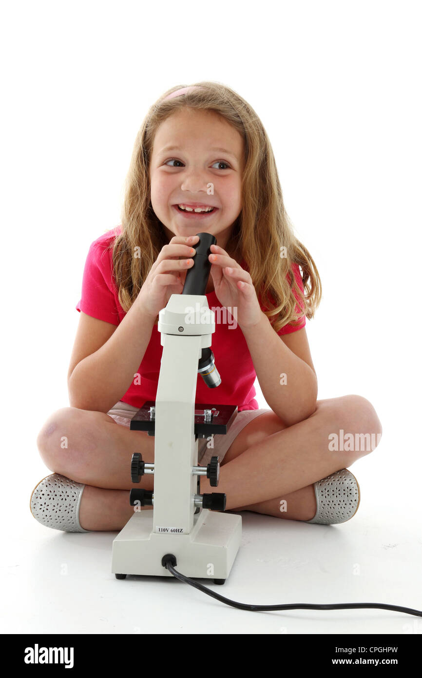 Young girl looking through a microscope on white background Stock Photo ...