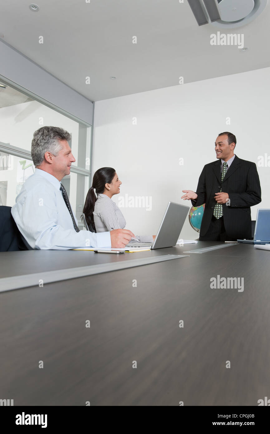 Three business people having meeting in office Stock Photo - Alamy