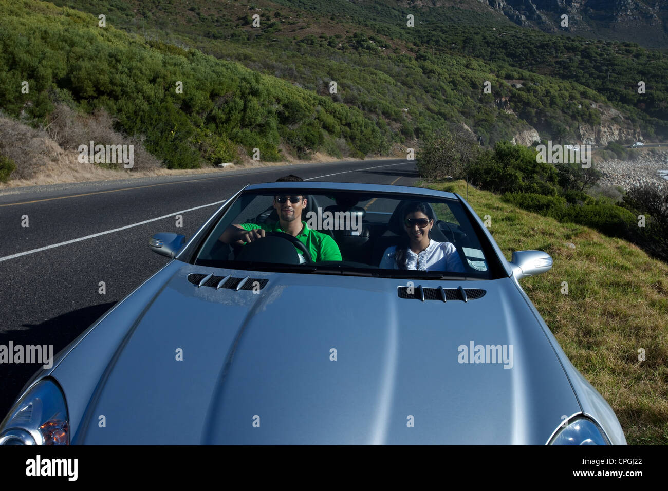 Couple riding in a convertible car, smiling Stock Photo - Alamy