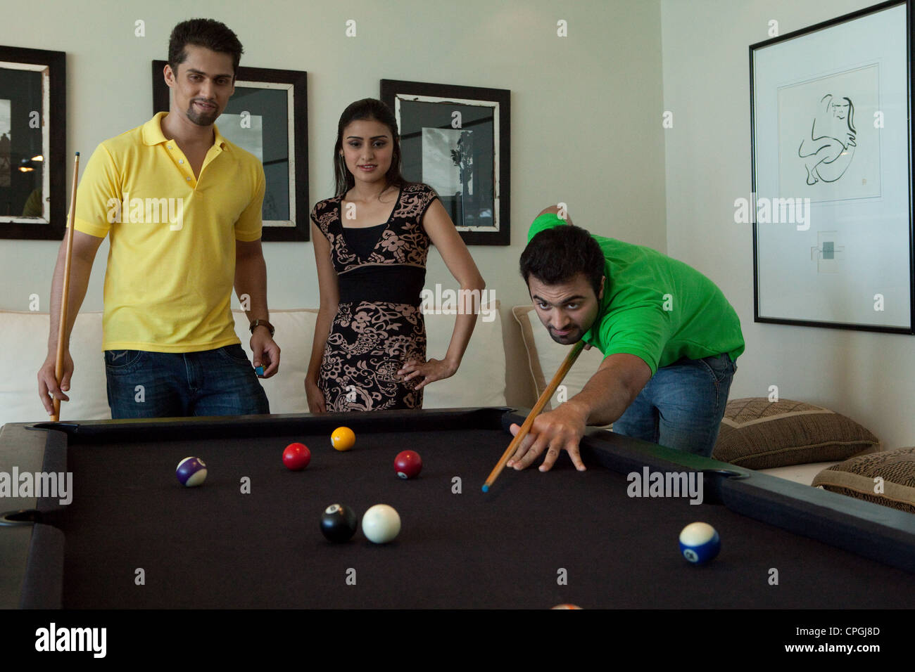 Friends playing billiard together Stock Photo - Alamy