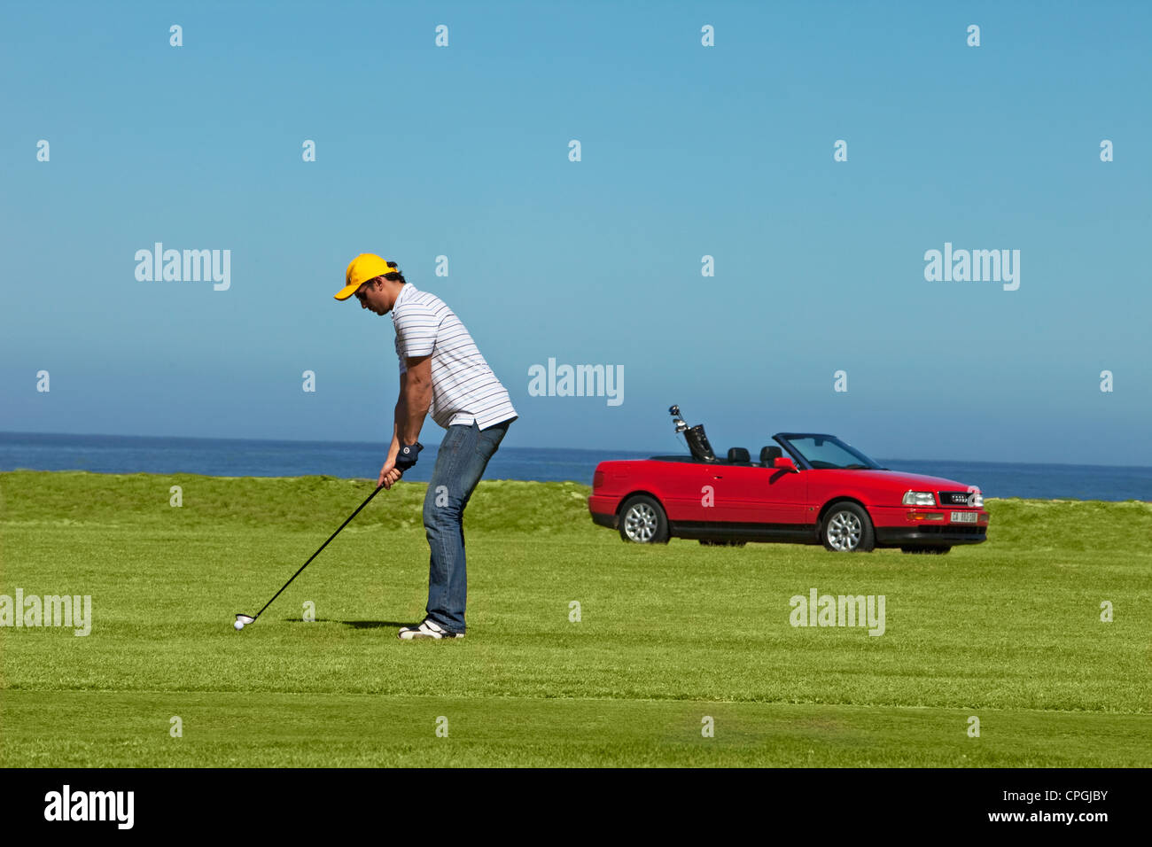 Man swinging a golf club Stock Photo - Alamy
