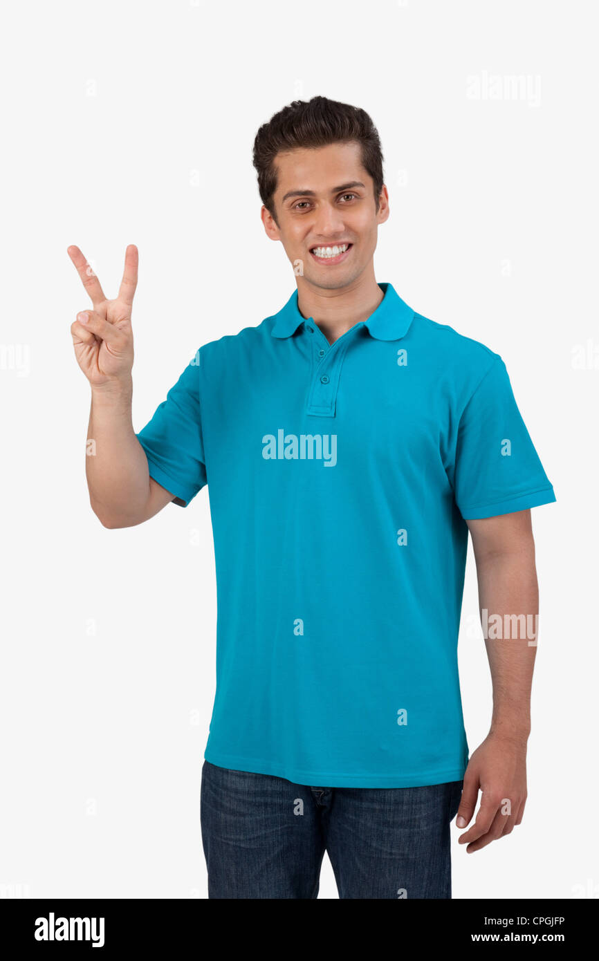 Portrait of a man showing peace sign Stock Photo - Alamy