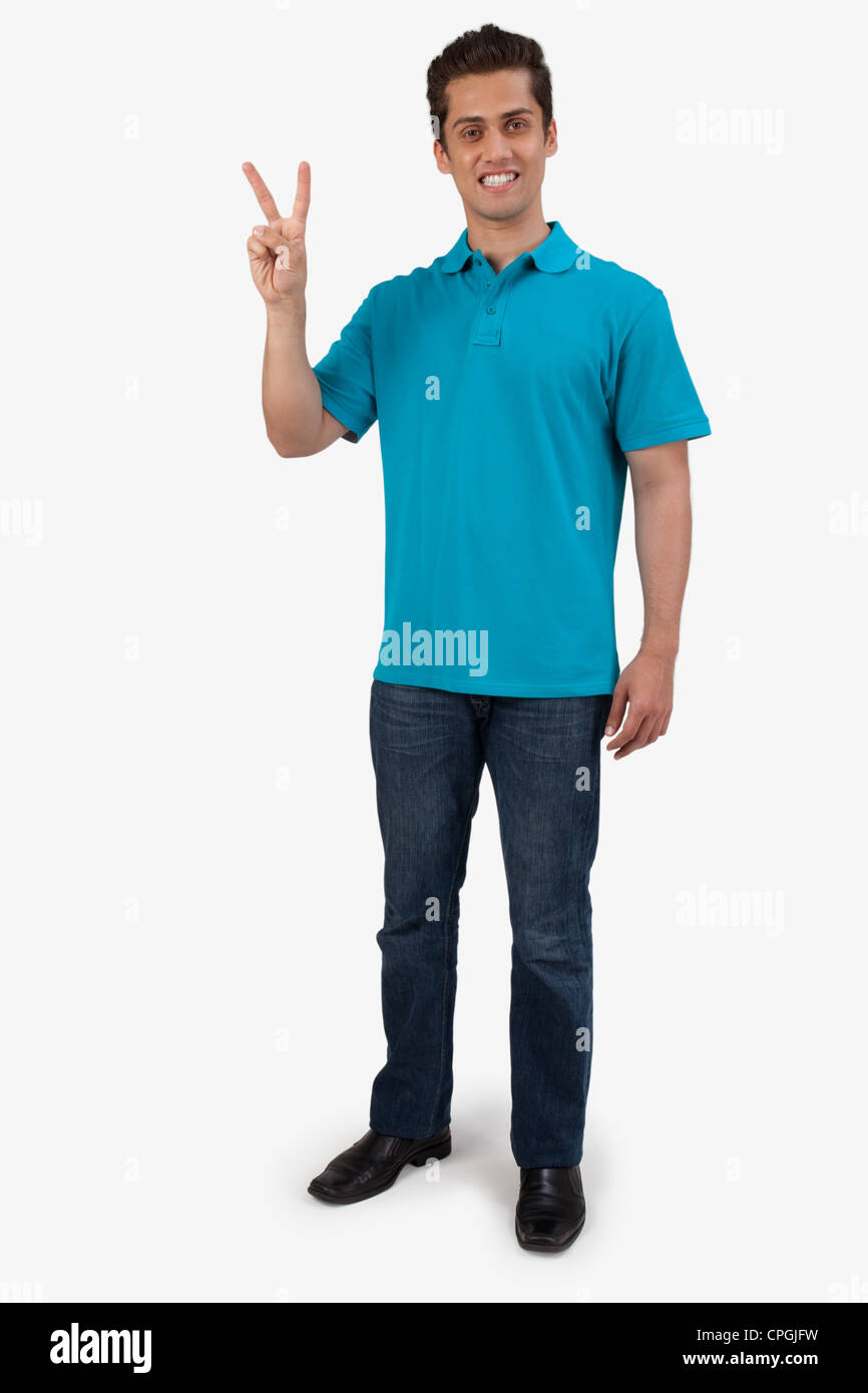 Portrait of a man showing peace sign Stock Photo - Alamy
