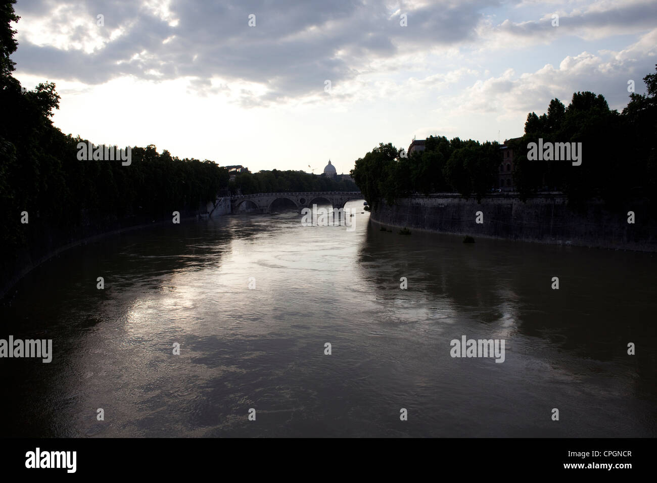 The Tiber river and St. Peter's Basilica at sunset in, Rome, Italy ...
