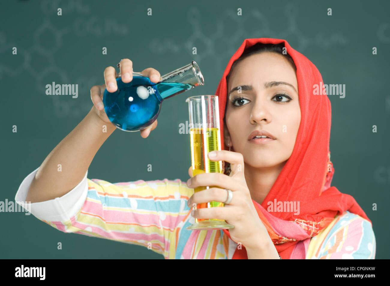 Teacher holding measuring tubes, close-up Stock Photo - Alamy