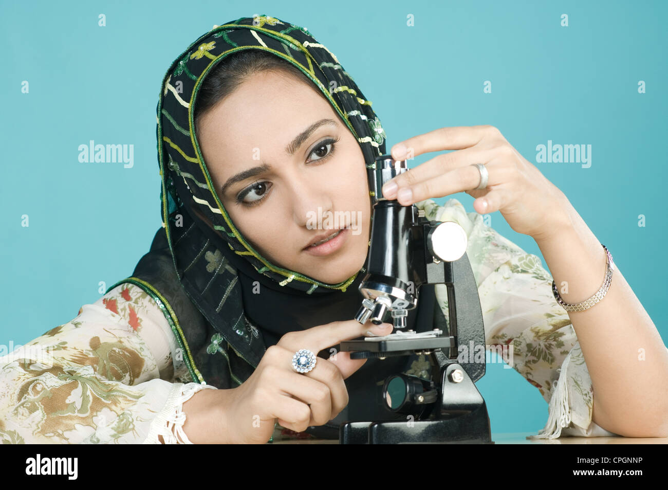 Woman looking into microscope, close-up, side view Stock Photo - Alamy