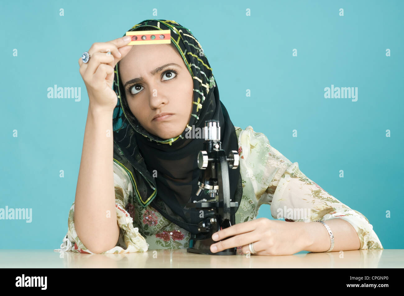 Woman with microscope looking at microscope slide Stock Photo - Alamy