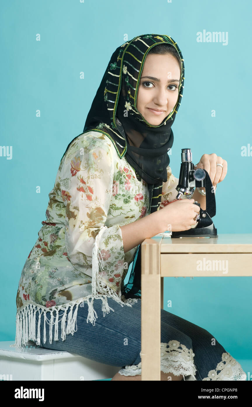 Woman sitting with microscope, portrait Stock Photo - Alamy