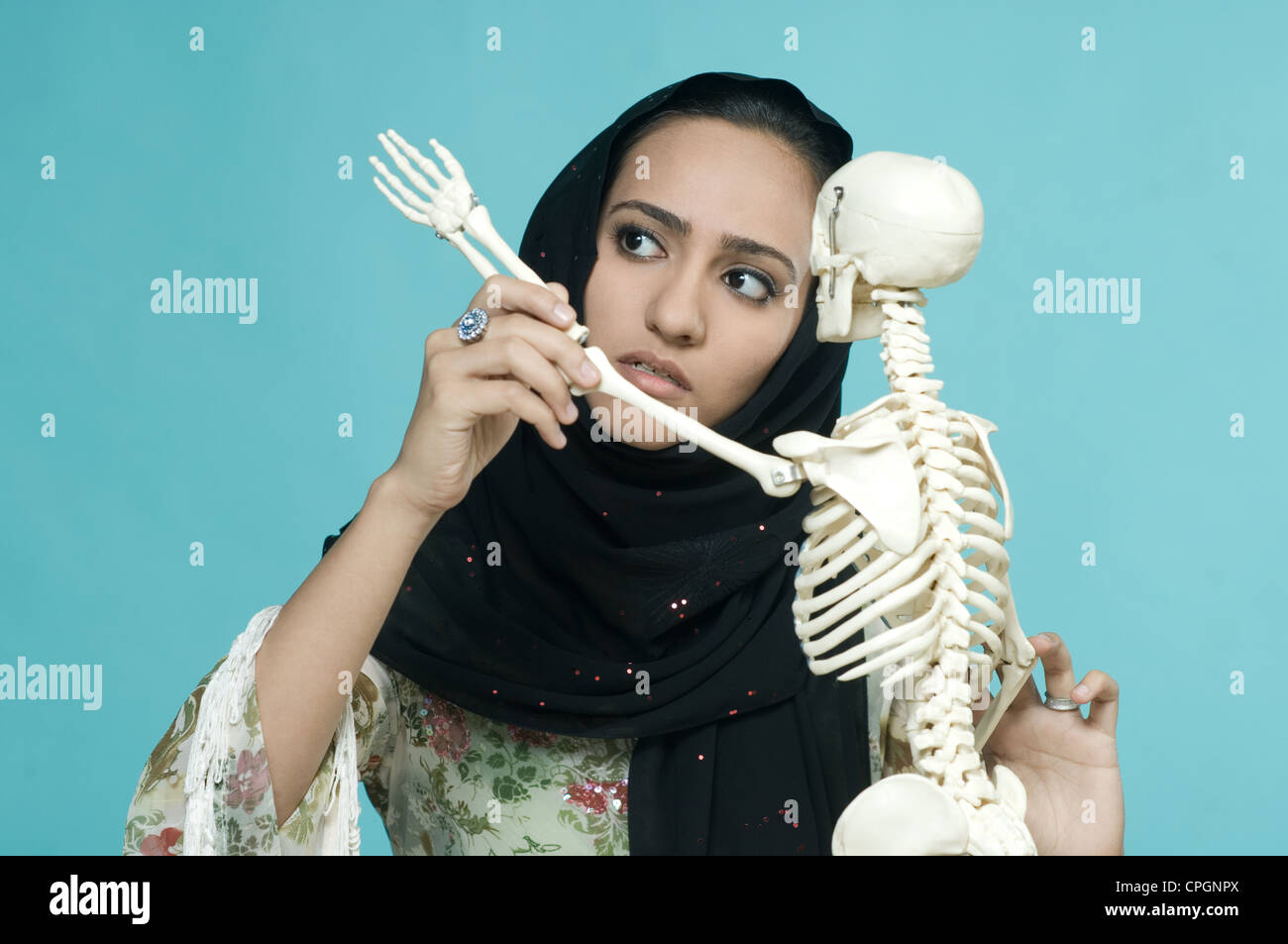 Woman holding human skeleton, close-up Stock Photo - Alamy