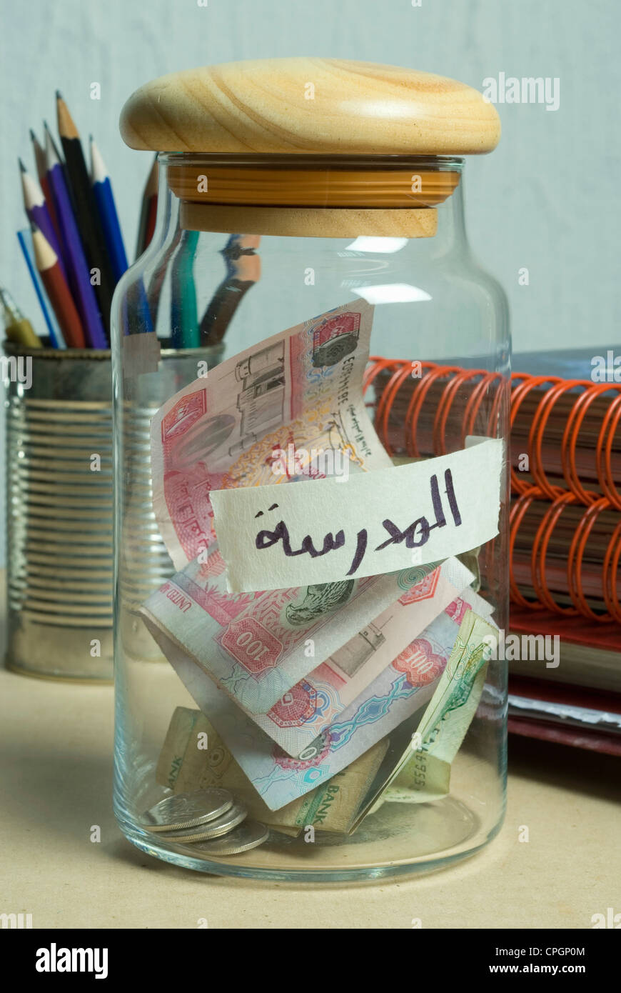 Money in container, close-up Stock Photo - Alamy