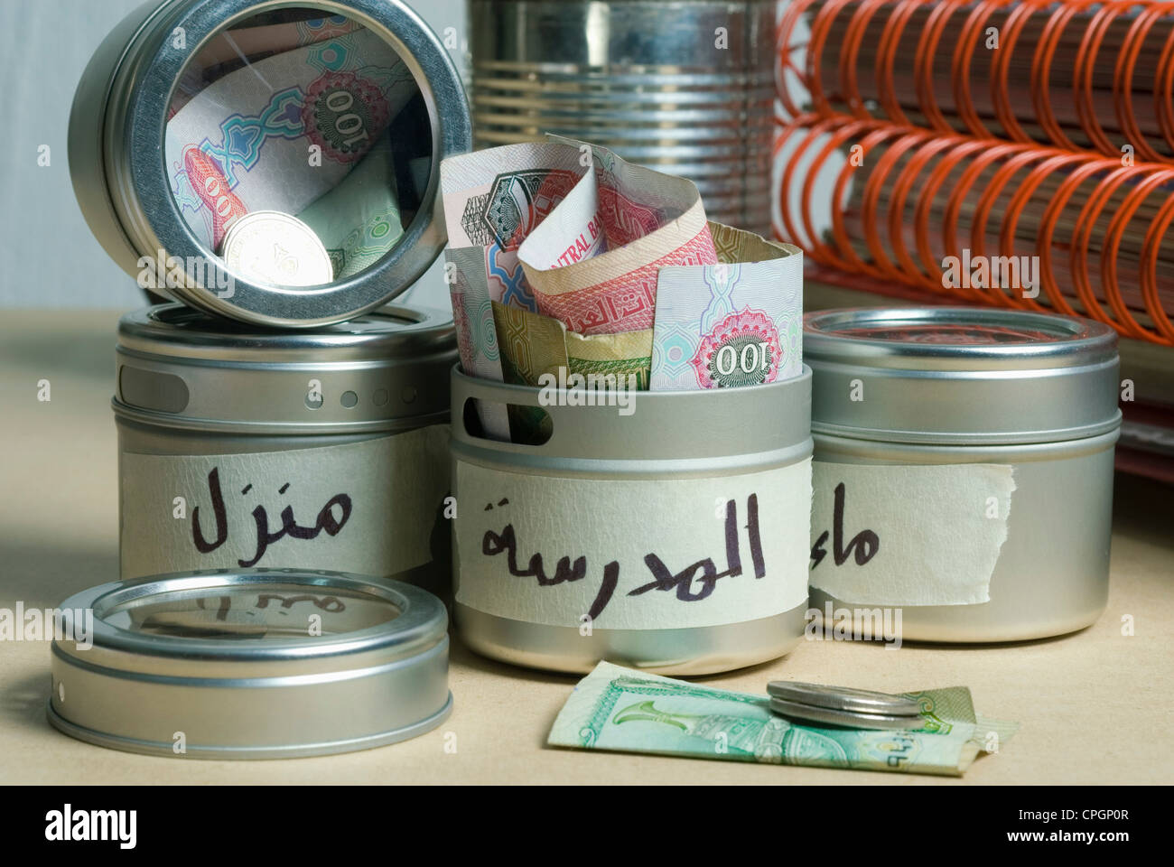 Money in containers, close-up Stock Photo - Alamy