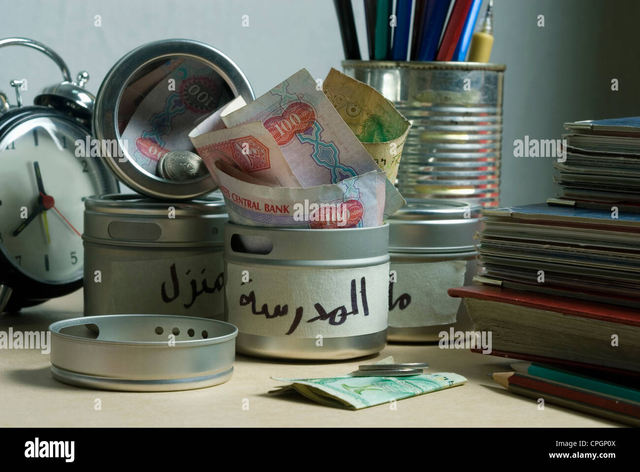 Money in containers, close-up Stock Photo - Alamy