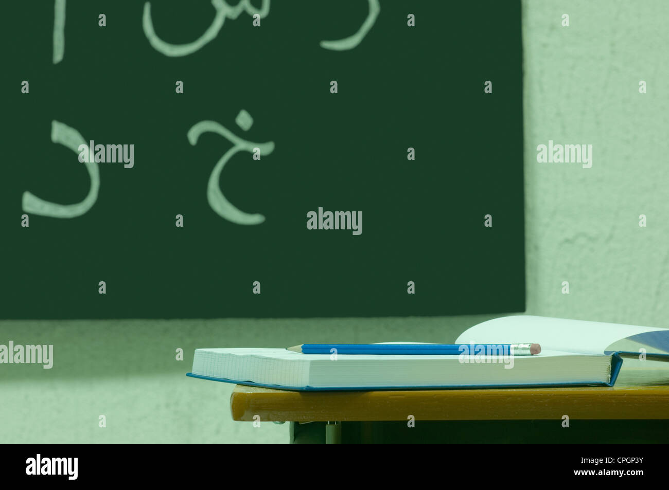 Script written on board in classroom Stock Photo - Alamy