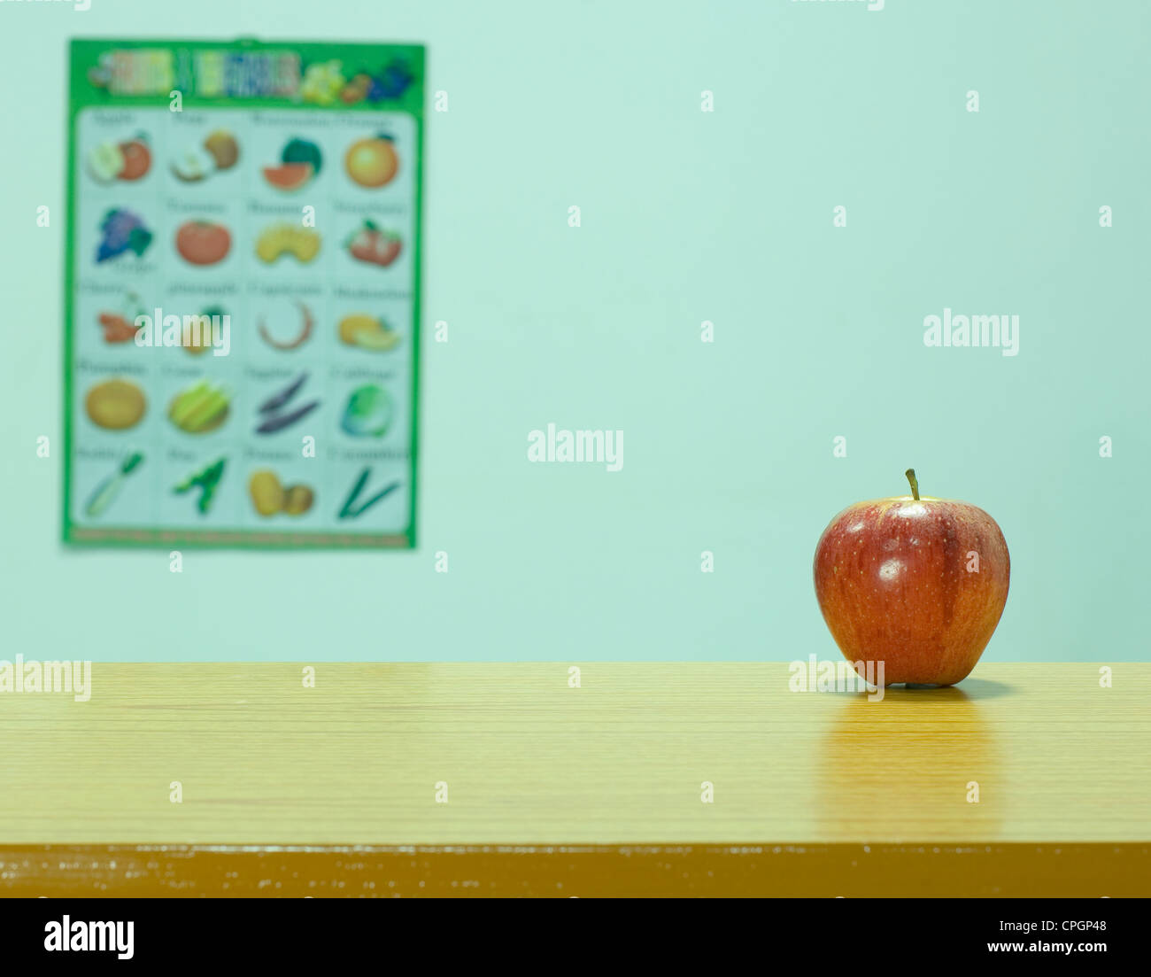Apple kept on table in classroom, close-up Stock Photo - Alamy