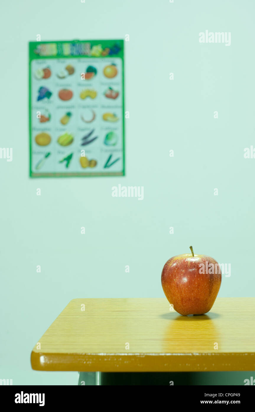 Apple kept on table in classroom, close-up Stock Photo - Alamy