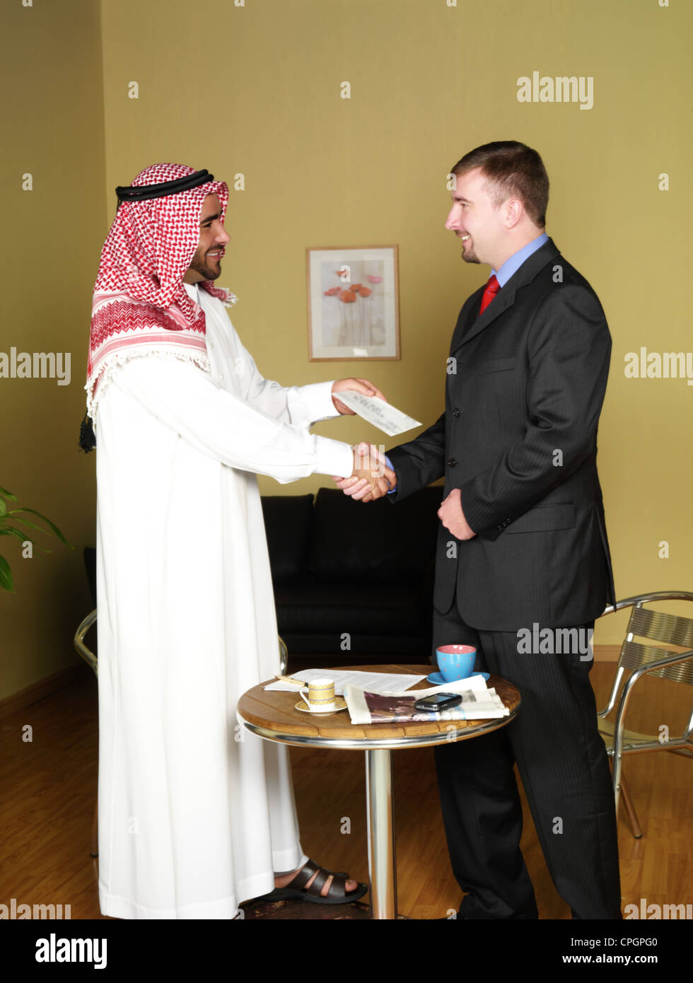 Businessman giving bank check, shaking hands, side view Stock Photo - Alamy