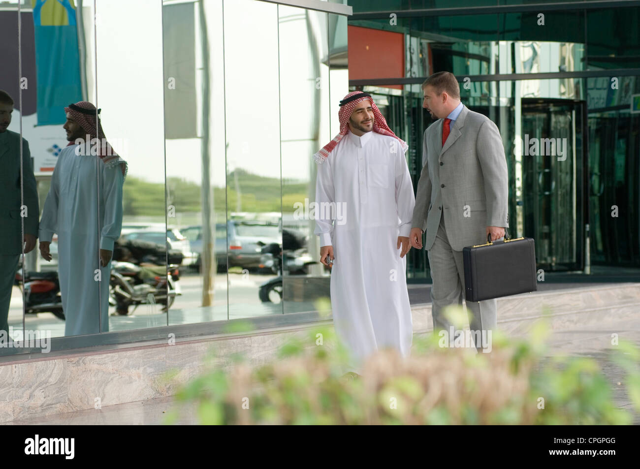 Businessmen walking on sidewalk Stock Photo - Alamy