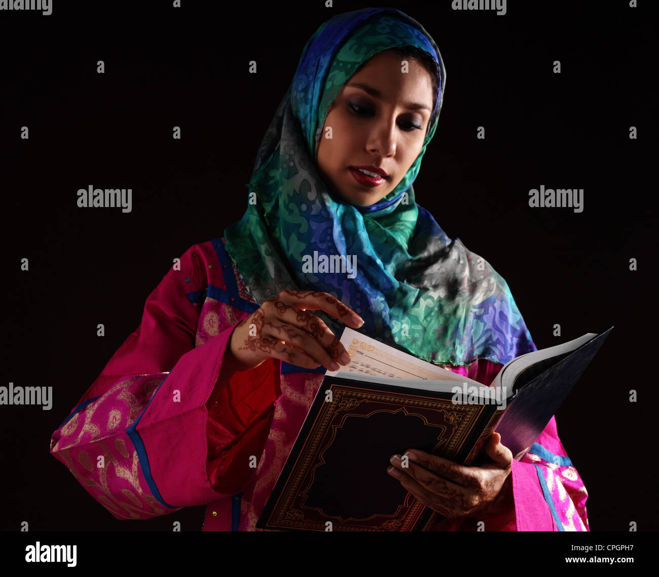 Young woman reading Koran Stock Photo - Alamy