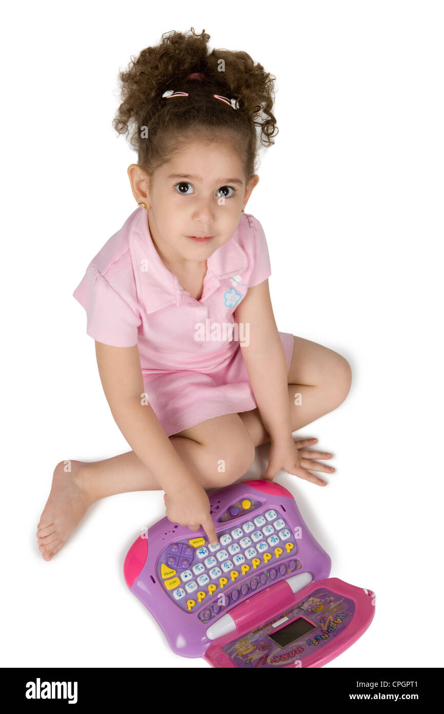 Girl playing with toy laptop, portrait Stock Photo - Alamy