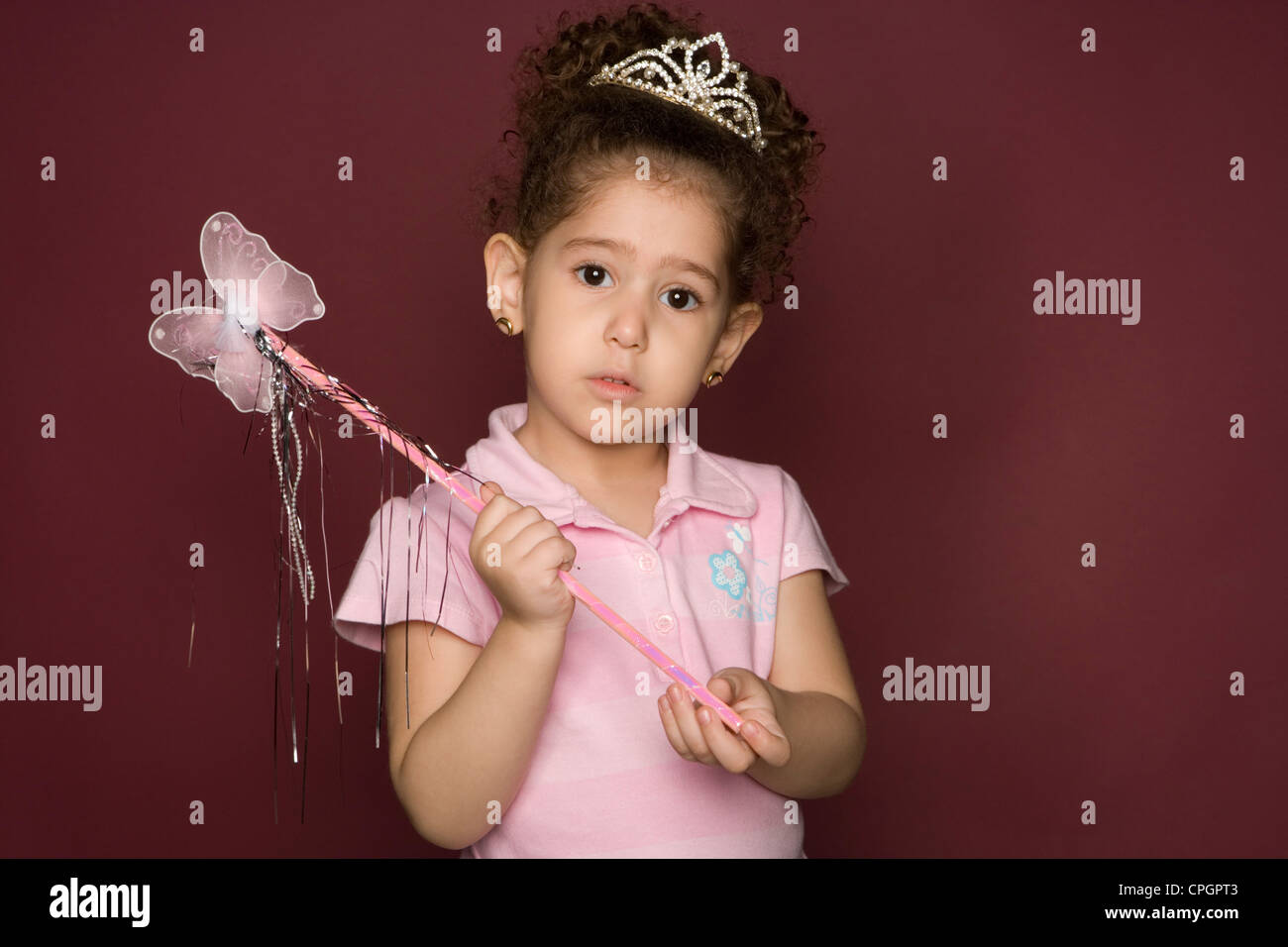 Girl holding magic wand, portrait Stock Photo - Alamy