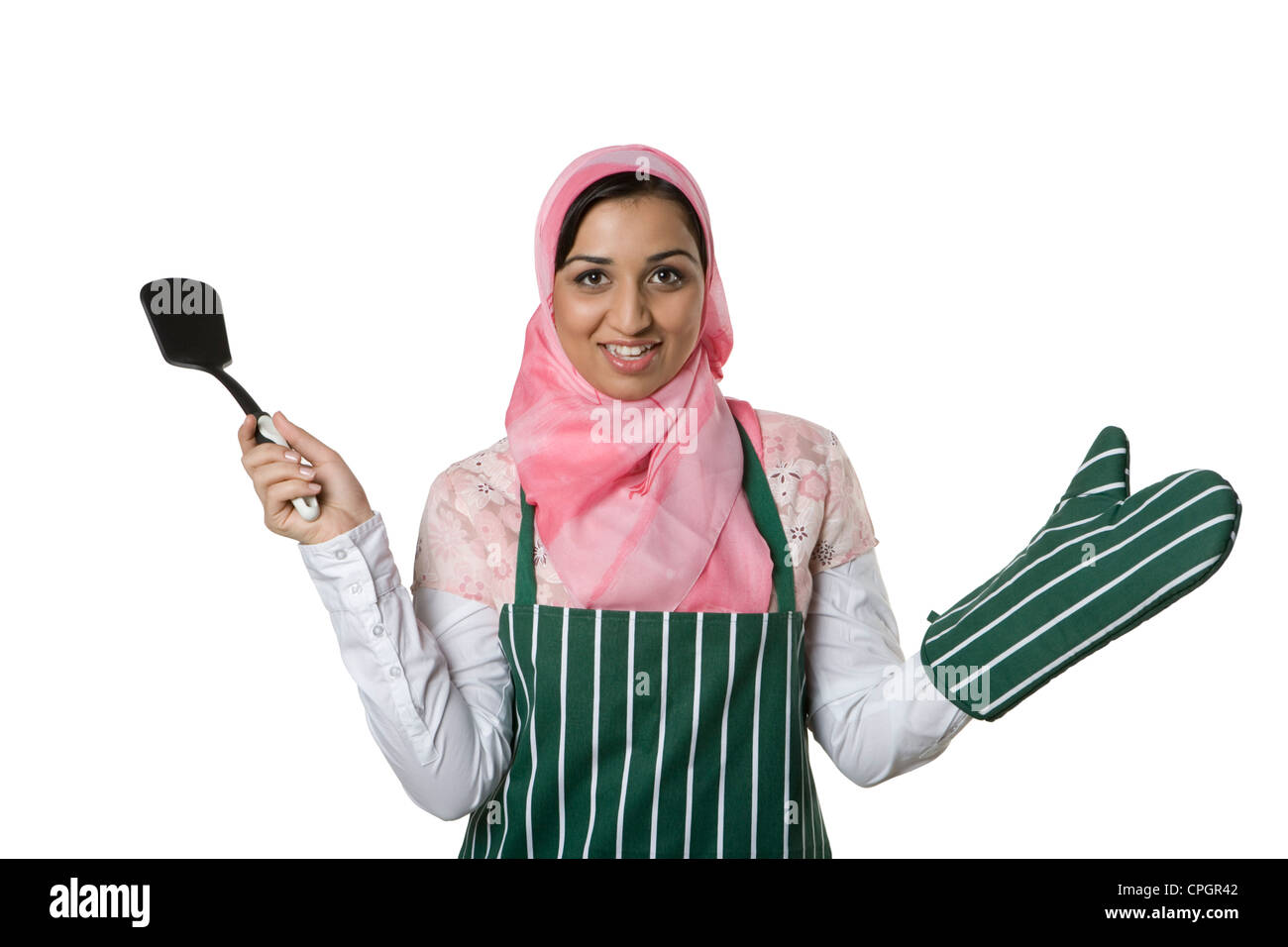 Young woman holding spatula, portrait Stock Photo - Alamy