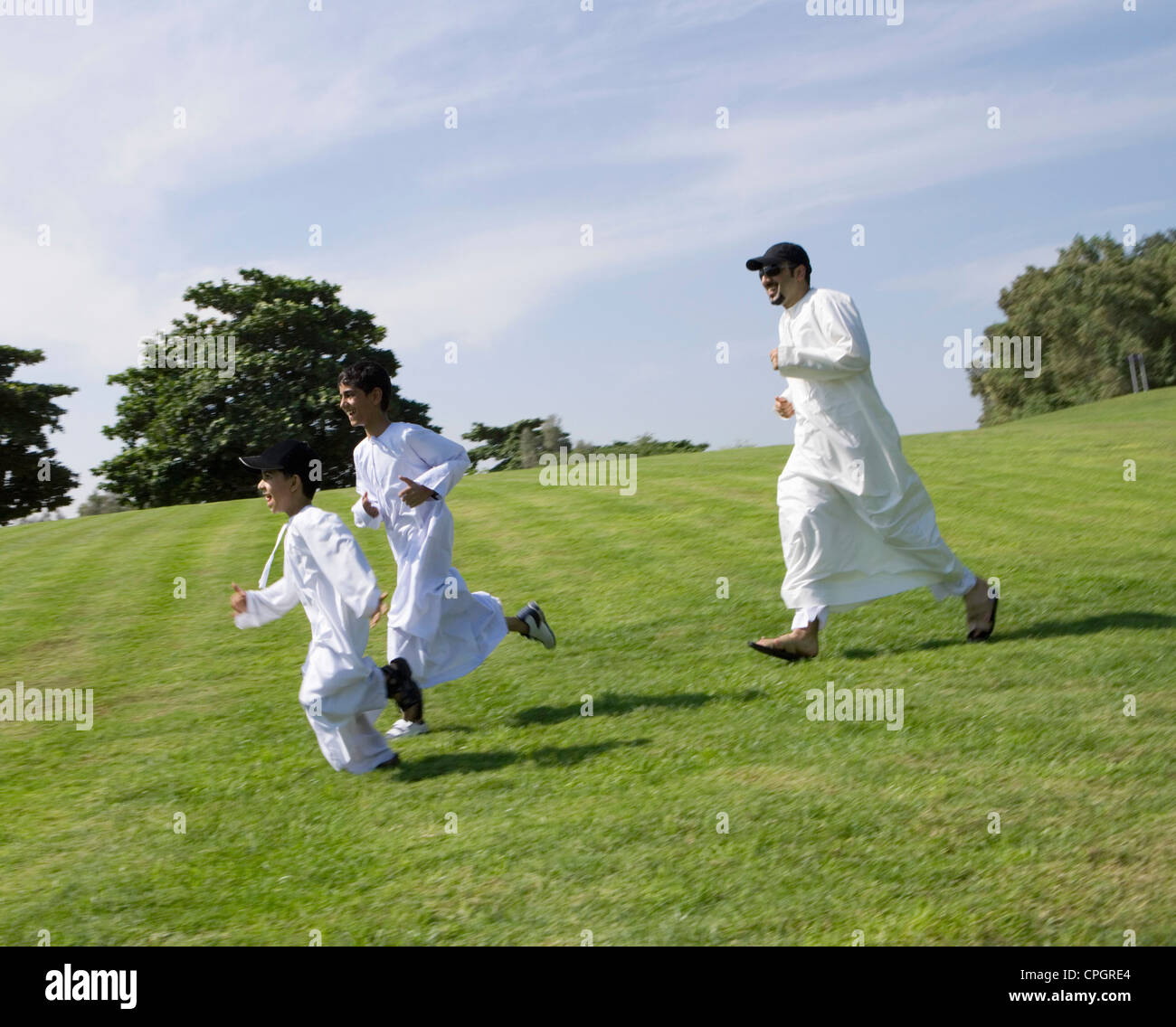 father and children running in park Stock Photo - Alamy