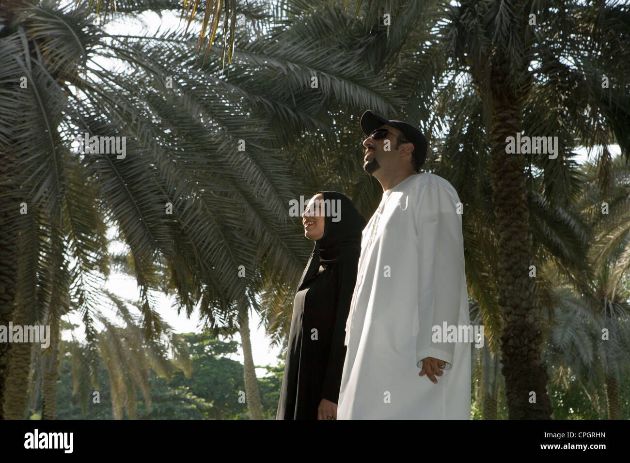 Palm tree man woman wearing traditional clothing hi-res stock ...