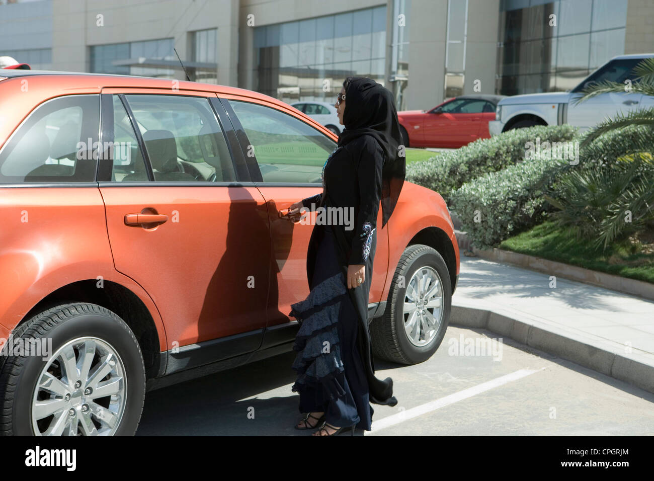 Young woman opening car door Stock Photo - Alamy