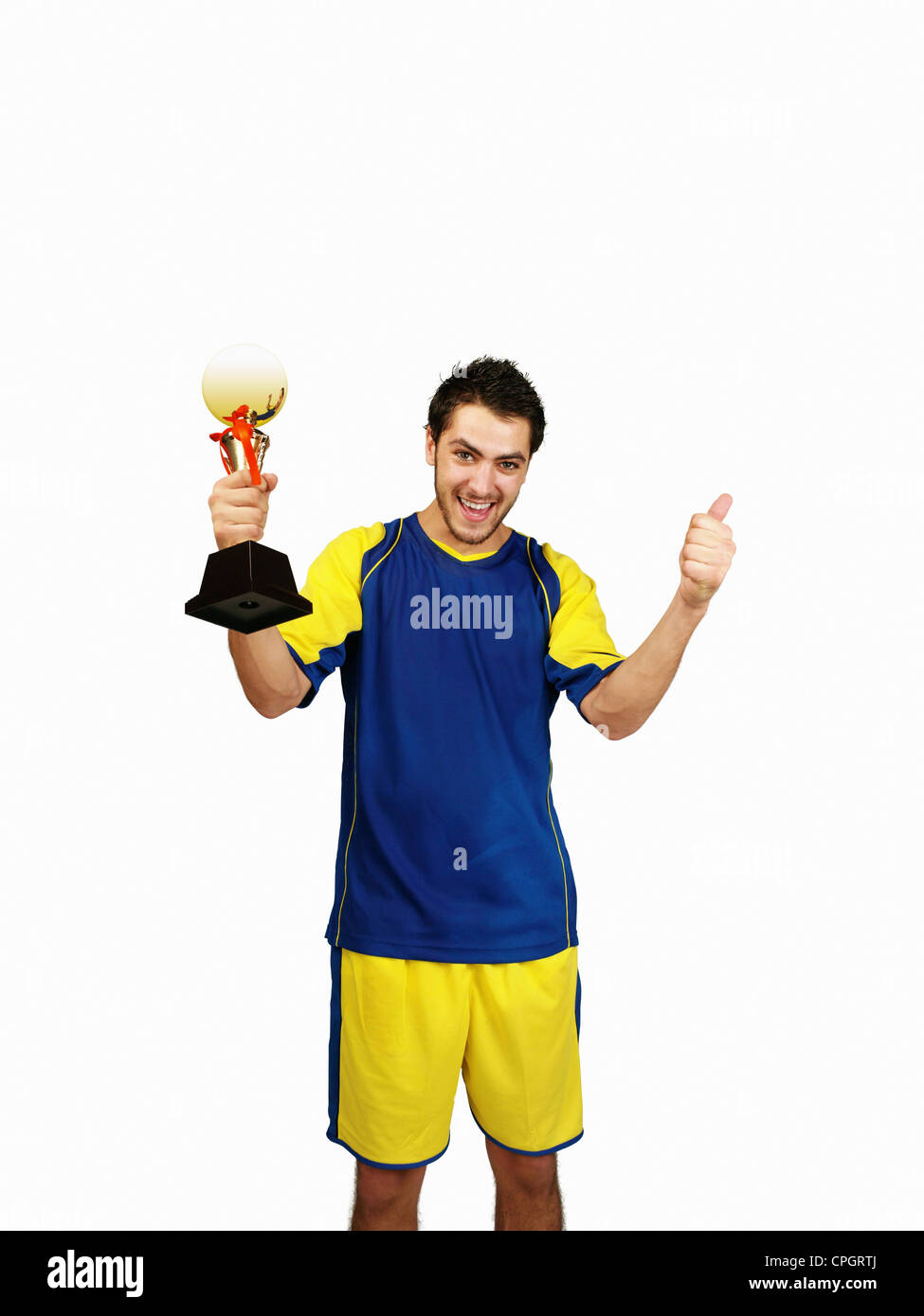 Young man showing thumbs up and holding trophy, smiling, portrait Stock ...