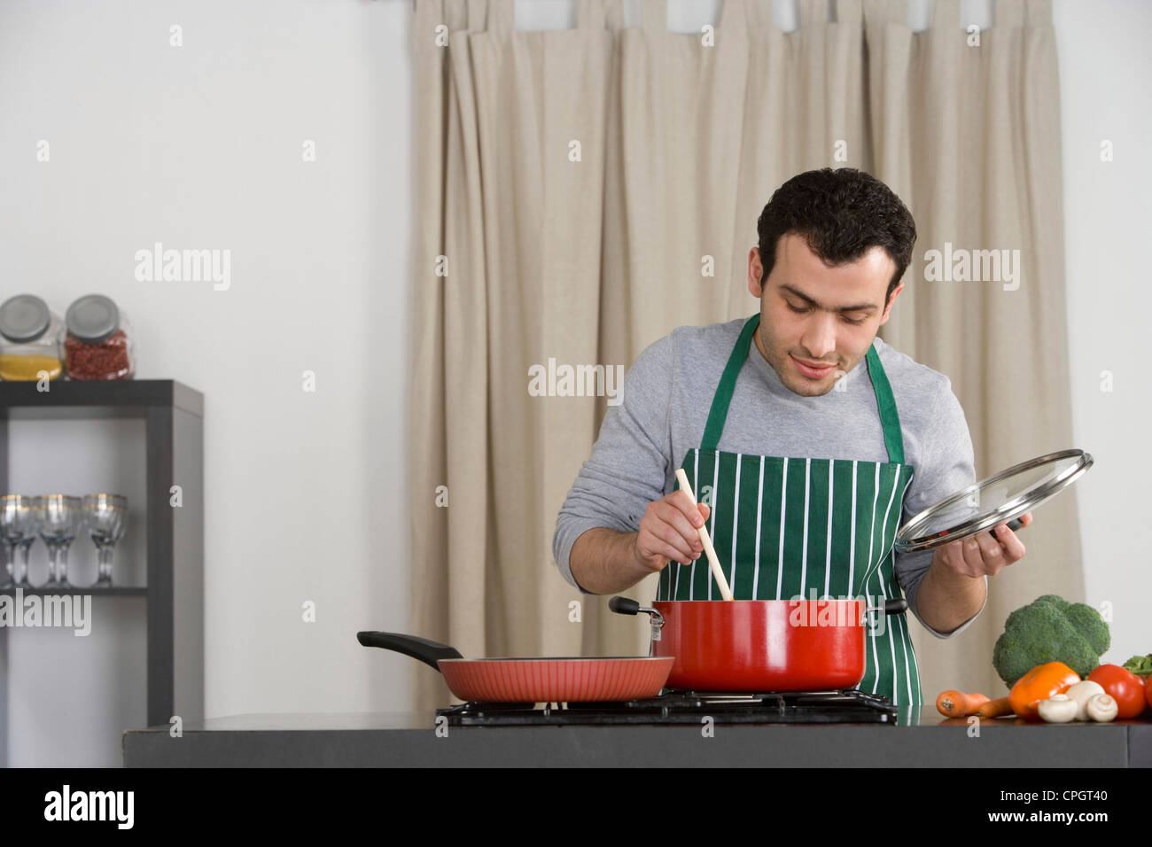Man cooking at the kitchen Stock Photo - Alamy