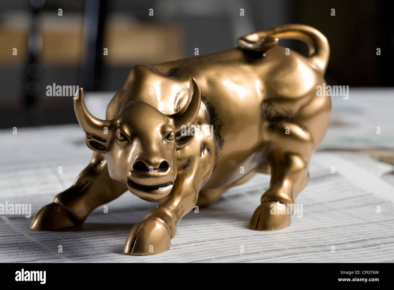 Bull figurine on newspaper, close-up Stock Photo - Alamy