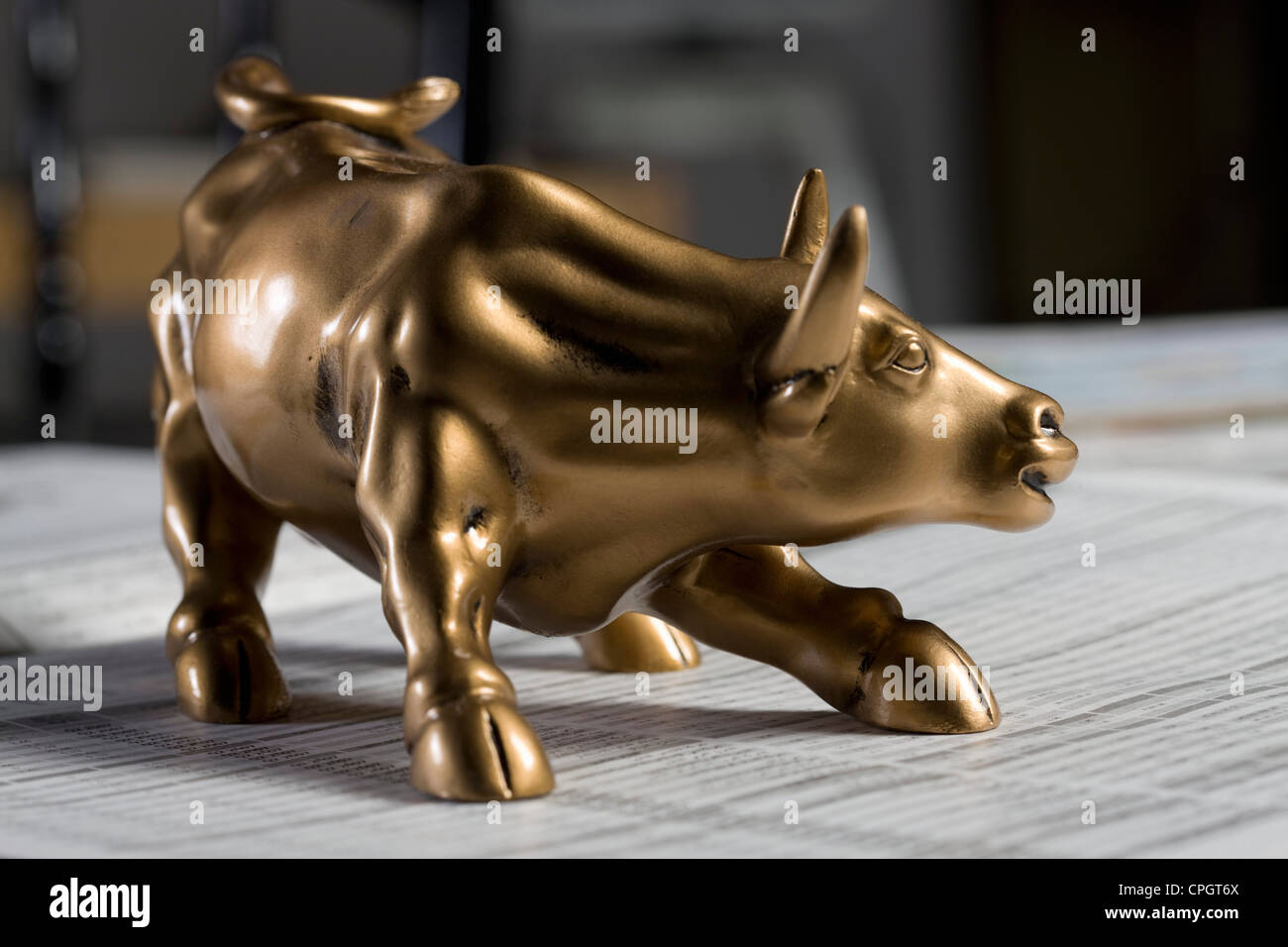 Bull figurine on newspaper, close-up Stock Photo - Alamy