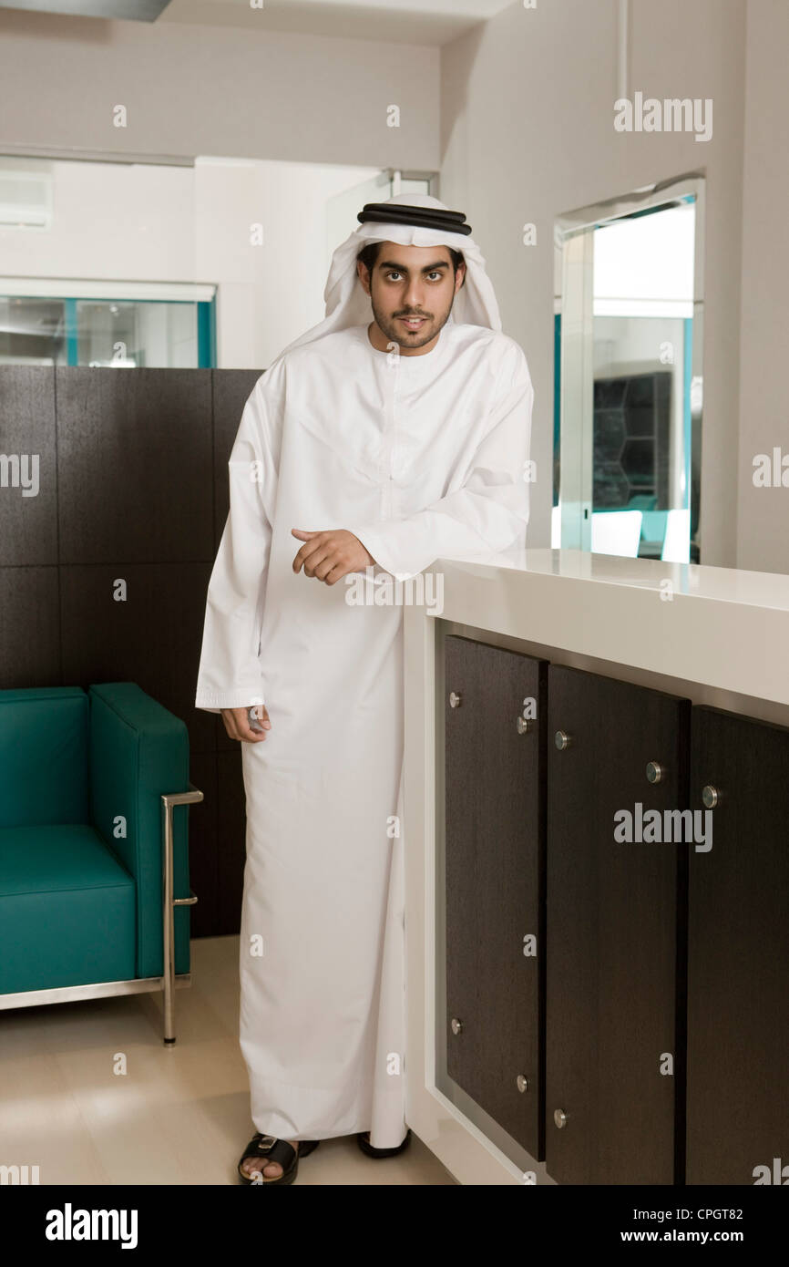 Man standing at reception desk, portrait Stock Photo - Alamy