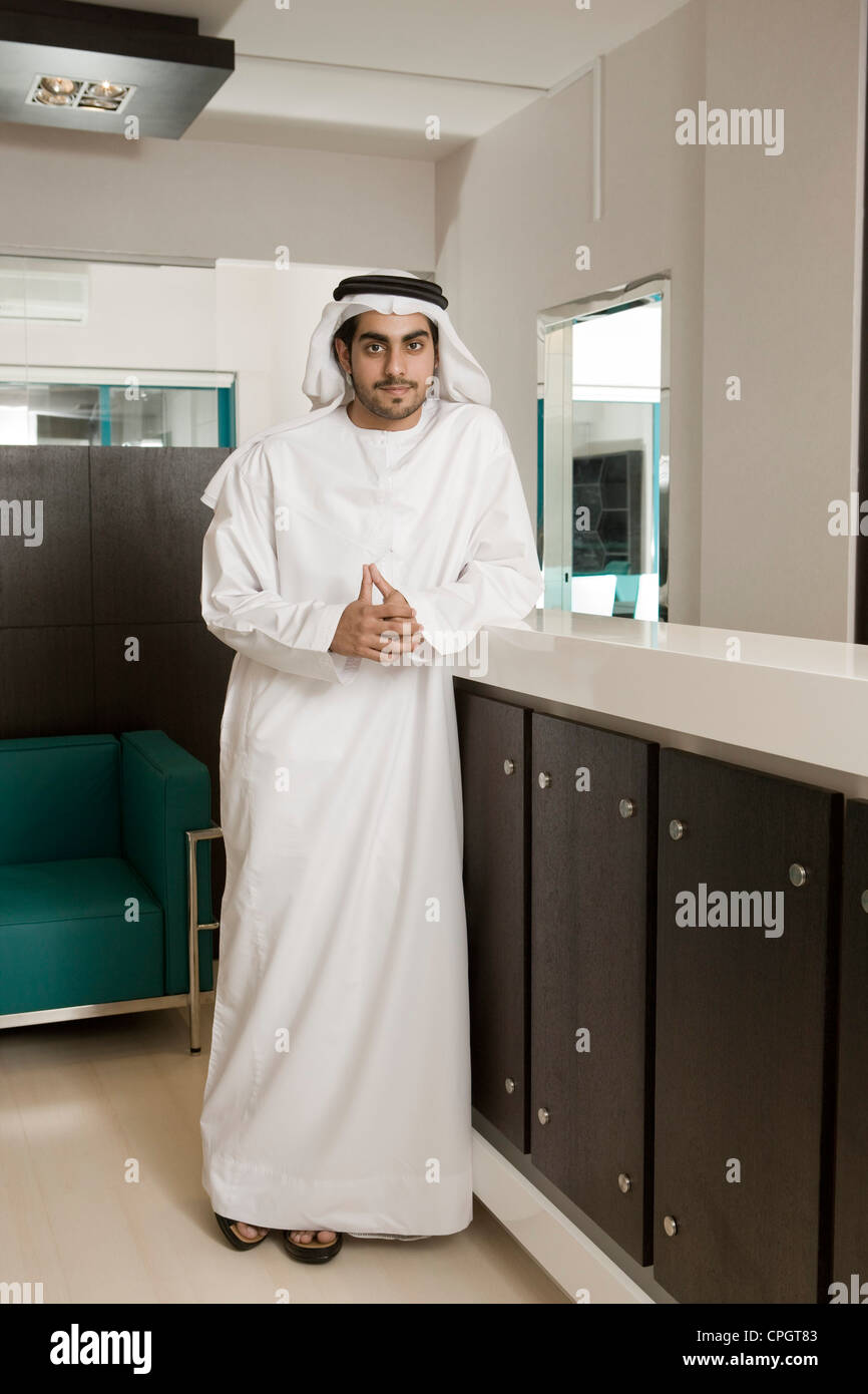 Man standing at reception desk, portrait Stock Photo - Alamy